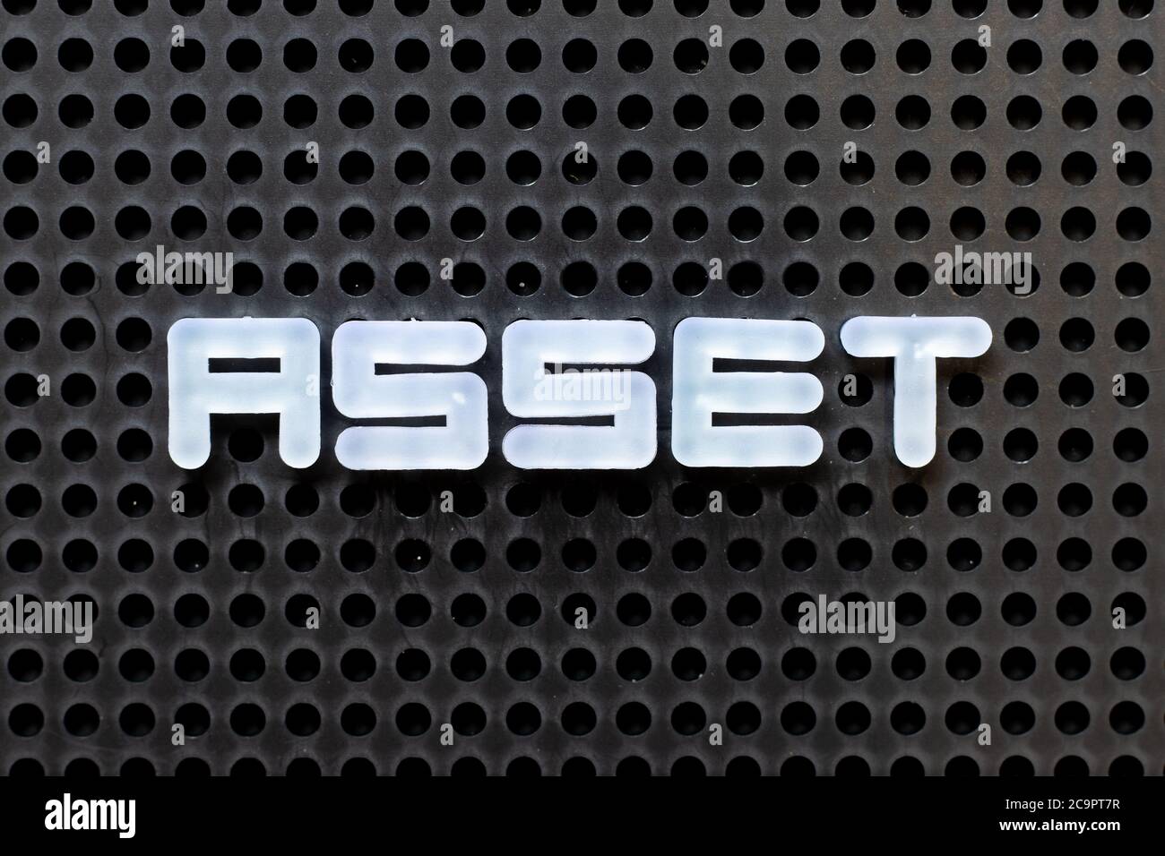 White color alphabet with word asset on black pegboard background Stock ...