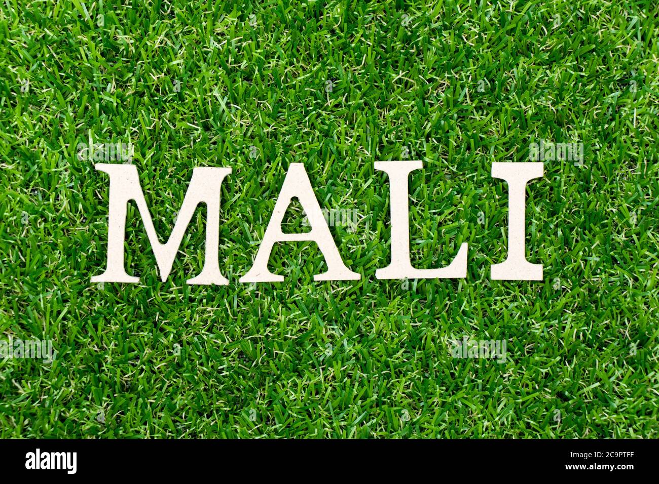 Wood letter in word mali on green grass background Stock Photo - Alamy