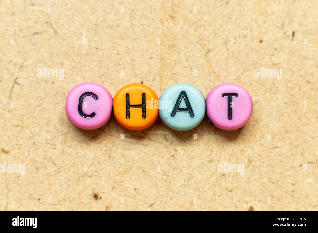 Round color bead with black letter in word chat on wood background ...