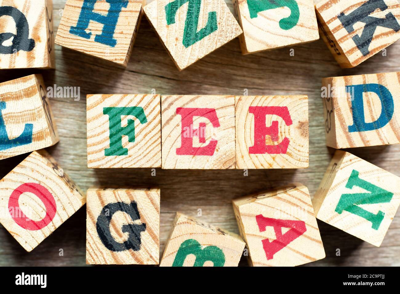Alphabet letter block in word fee with another on wood background Stock ...