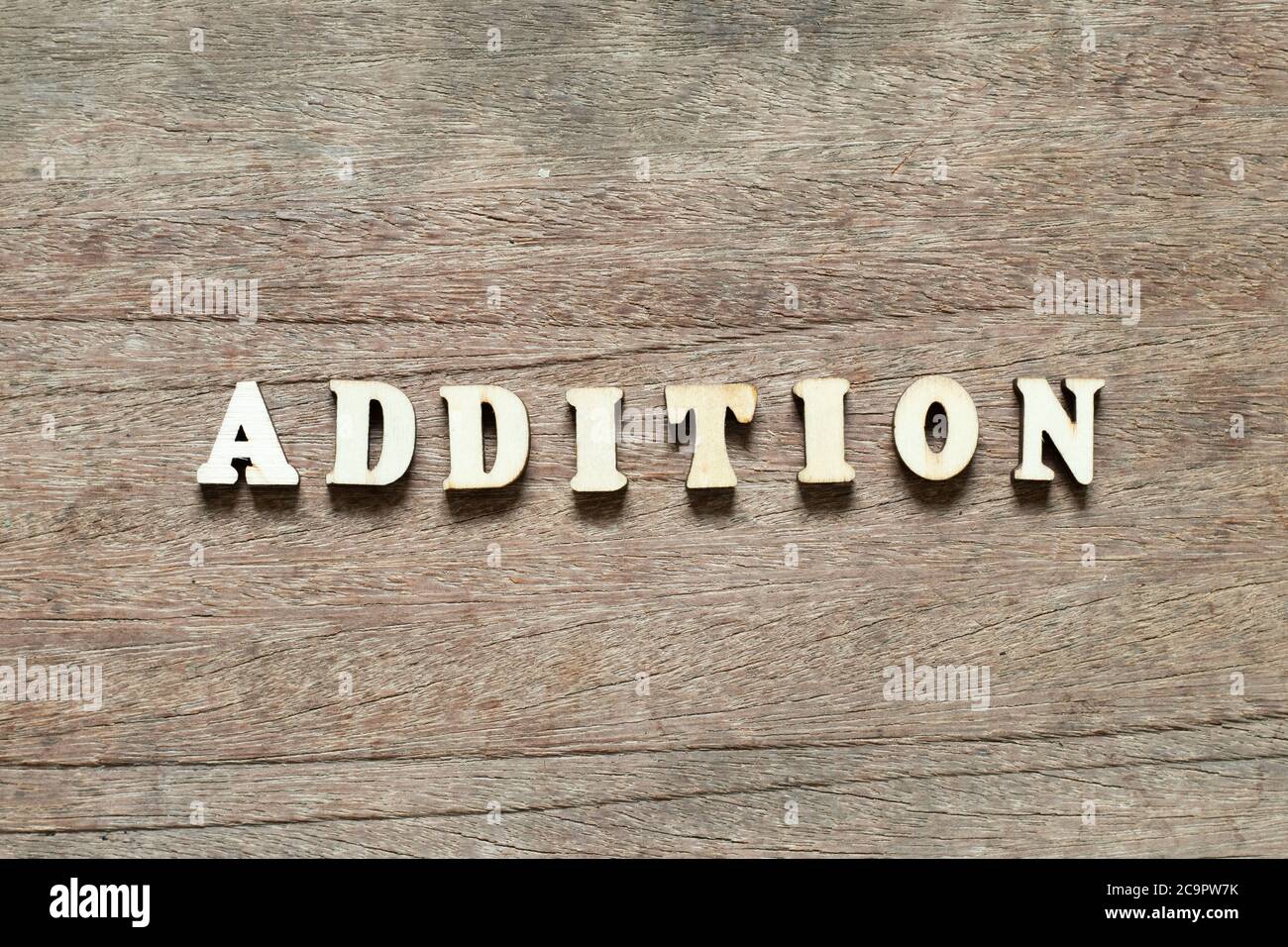 Alphabet letter block in word addition on wood background Stock Photo ...