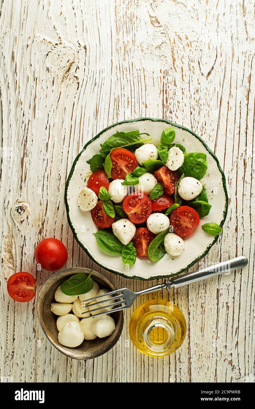 Delicious caprese salad with ripe tomatoes and mozzarella cheese with ...
