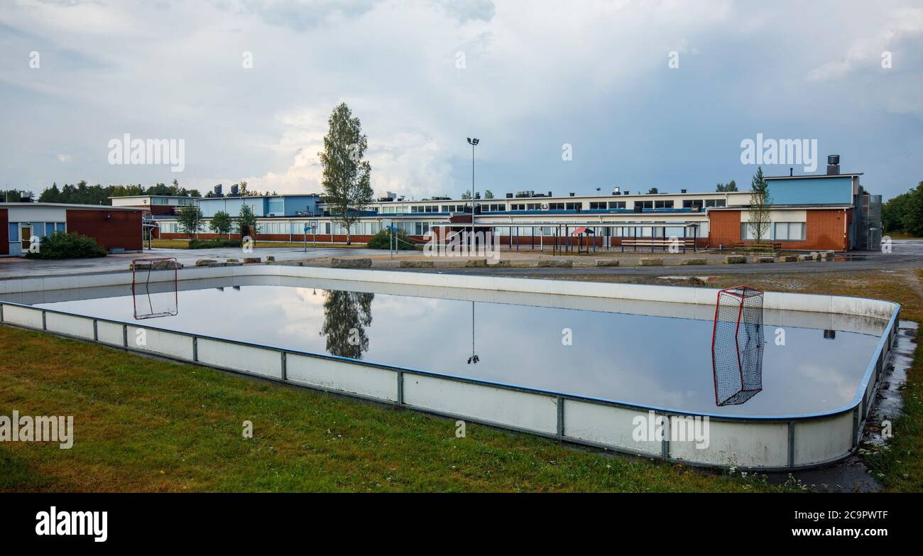 View of water-filled outdoor floorball court at schoolyard , Finland ...