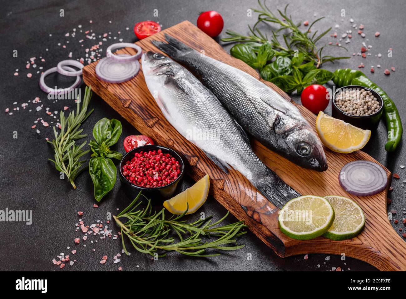 Fresh fish seabass and ingredients for cooking. Raw fish seabass with ...