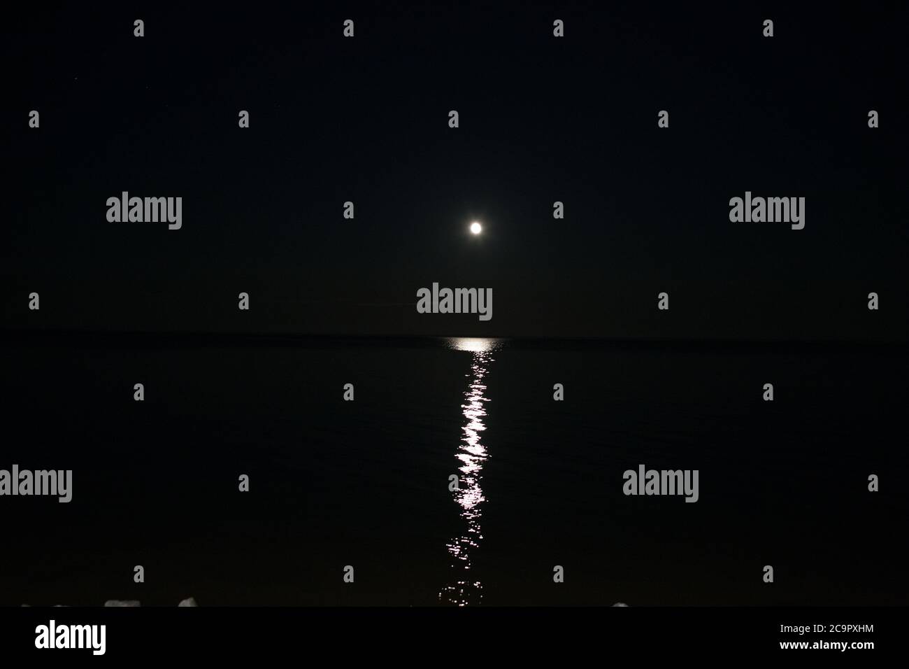 a moon path in the night sky at sea Stock Photo - Alamy