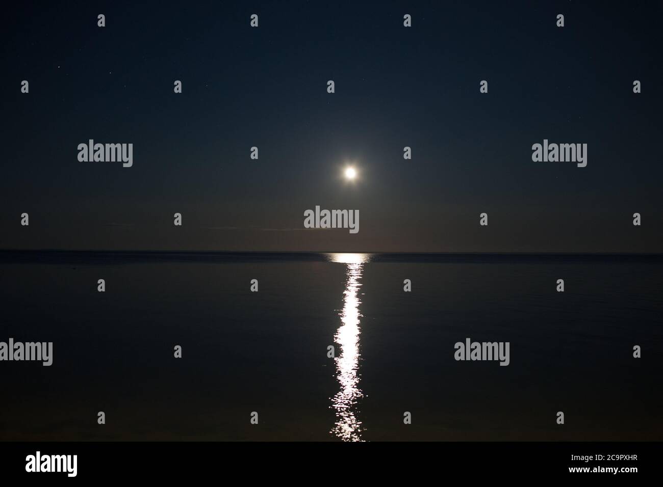 a moon path in the night sky at sea Stock Photo - Alamy