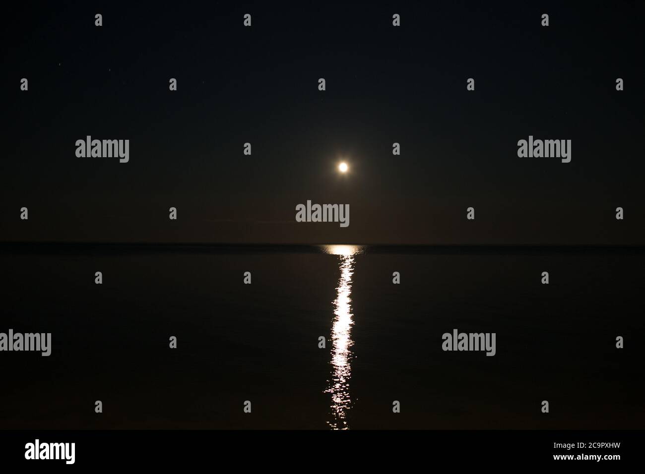 a moon path in the night sky at sea Stock Photo - Alamy