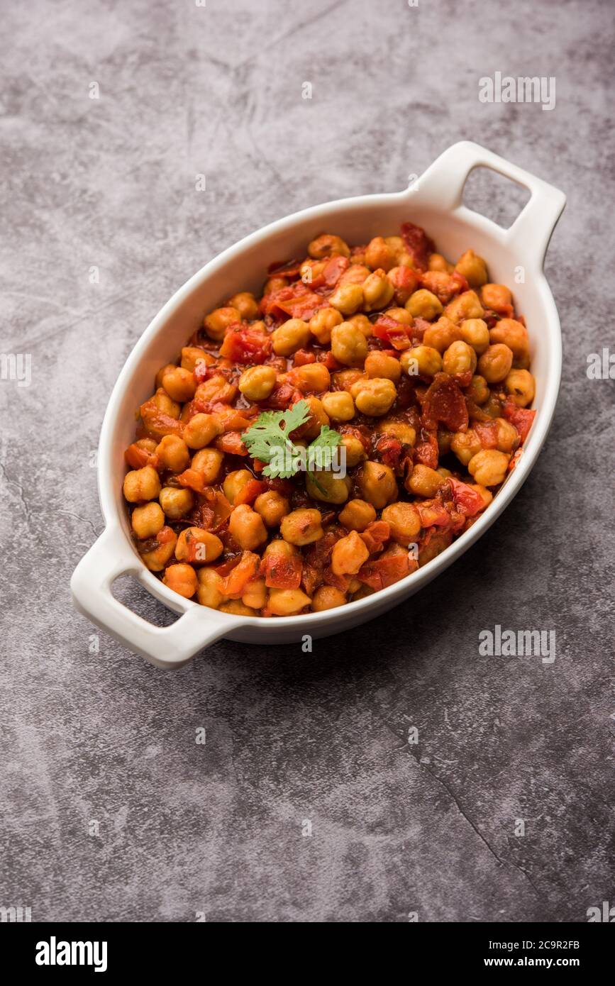 Spicy Chickpea curry, Chana Masala or Choley in bowl with chapati and ...