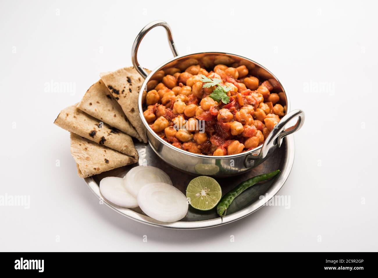 Spicy Chickpea curry, Chana Masala or Choley in bowl with chapati and ...