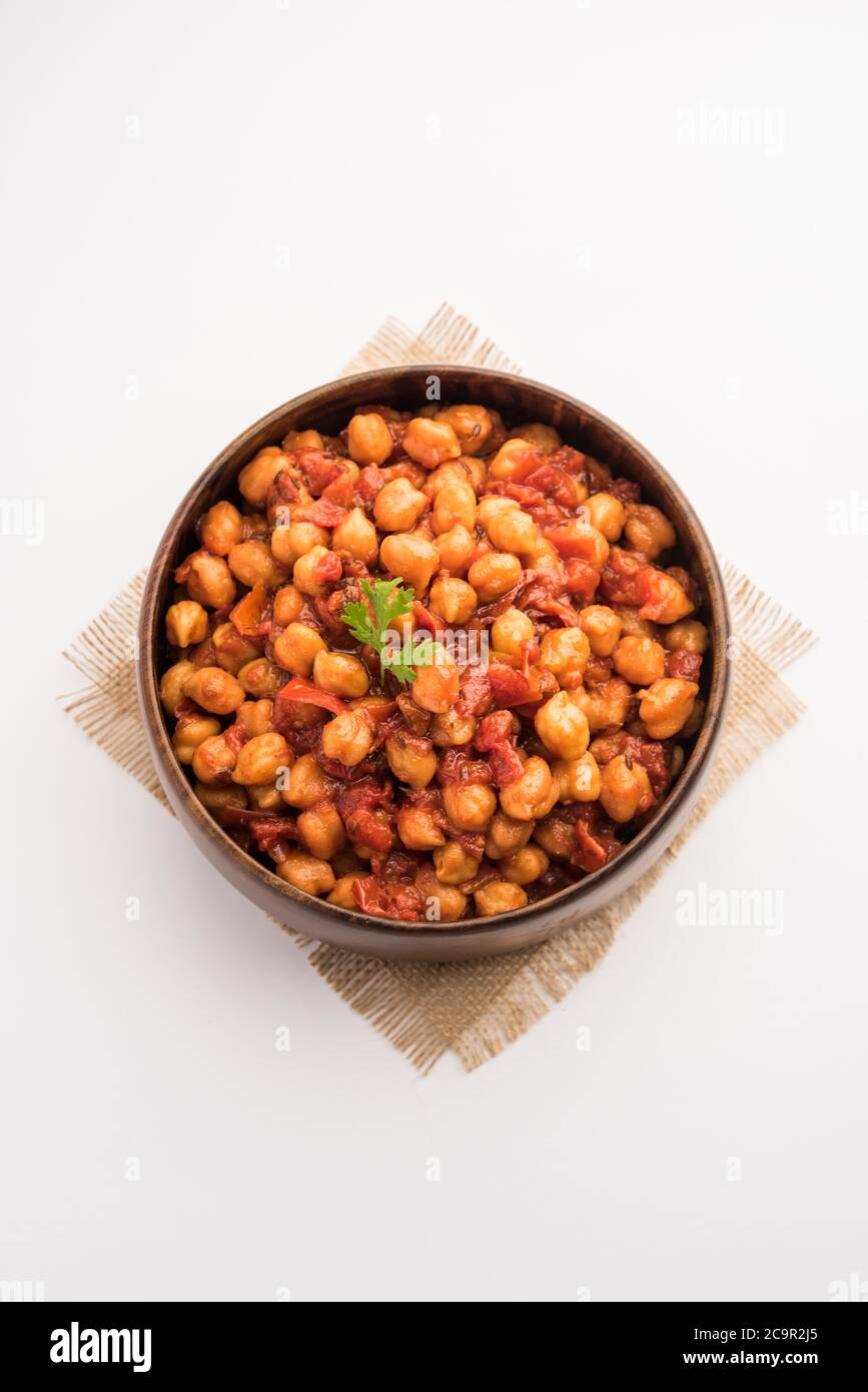 Spicy Chickpea curry, Chana Masala or Choley in bowl with chapati and ...