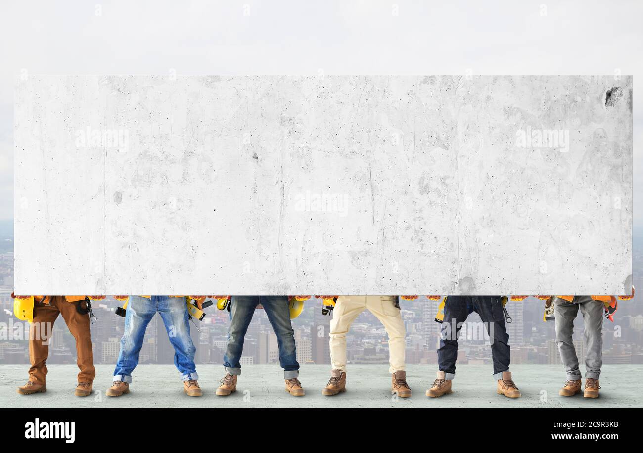 Builders with tools in construction clothing hold a heavy slab Stock ...