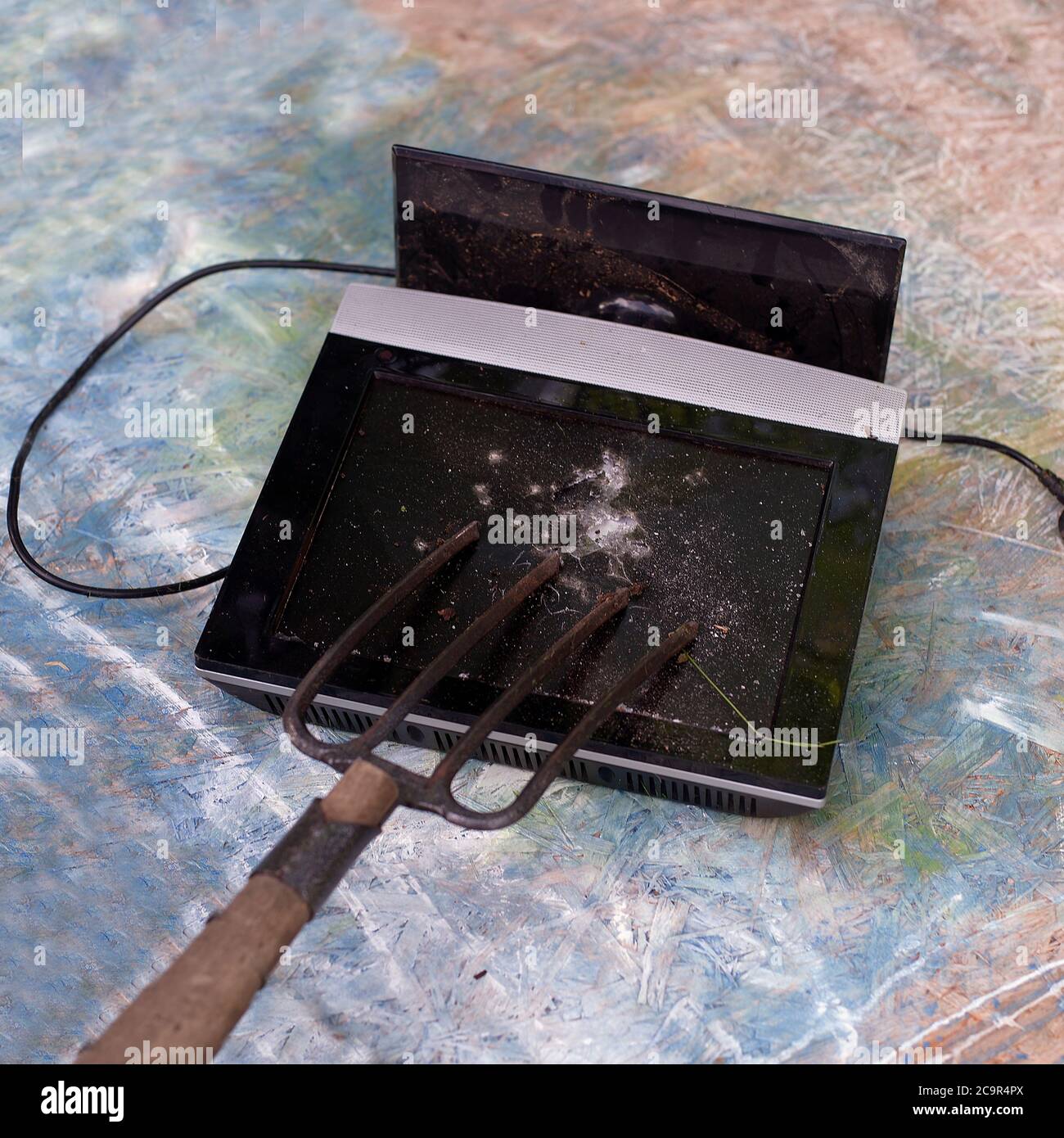 Computerr monitor stabbed with a pitchfork, closeup conceptual image ...