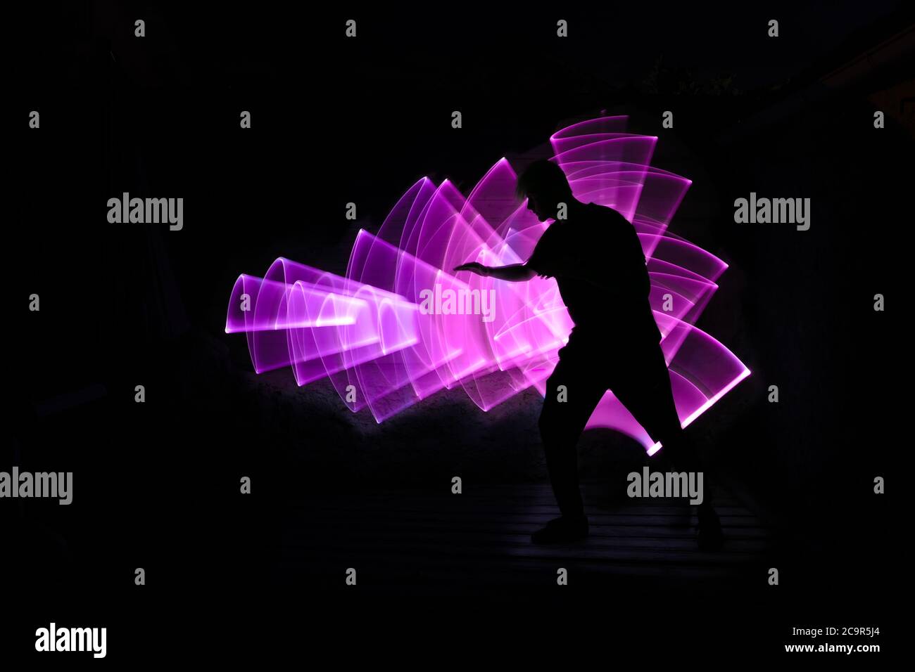 Silhouette of a man in profile with outstretched arm. Abstract light ...