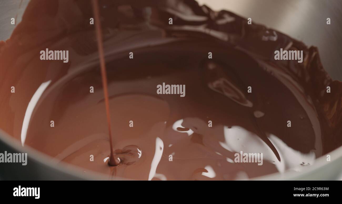 mixing dark melted chocolate with spoon closeup Stock Photo - Alamy