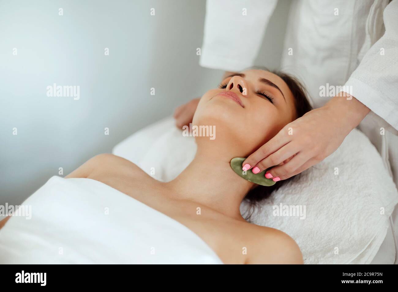 Face gua sha massage or beauty treatment in spa salon Stock Photo - Alamy
