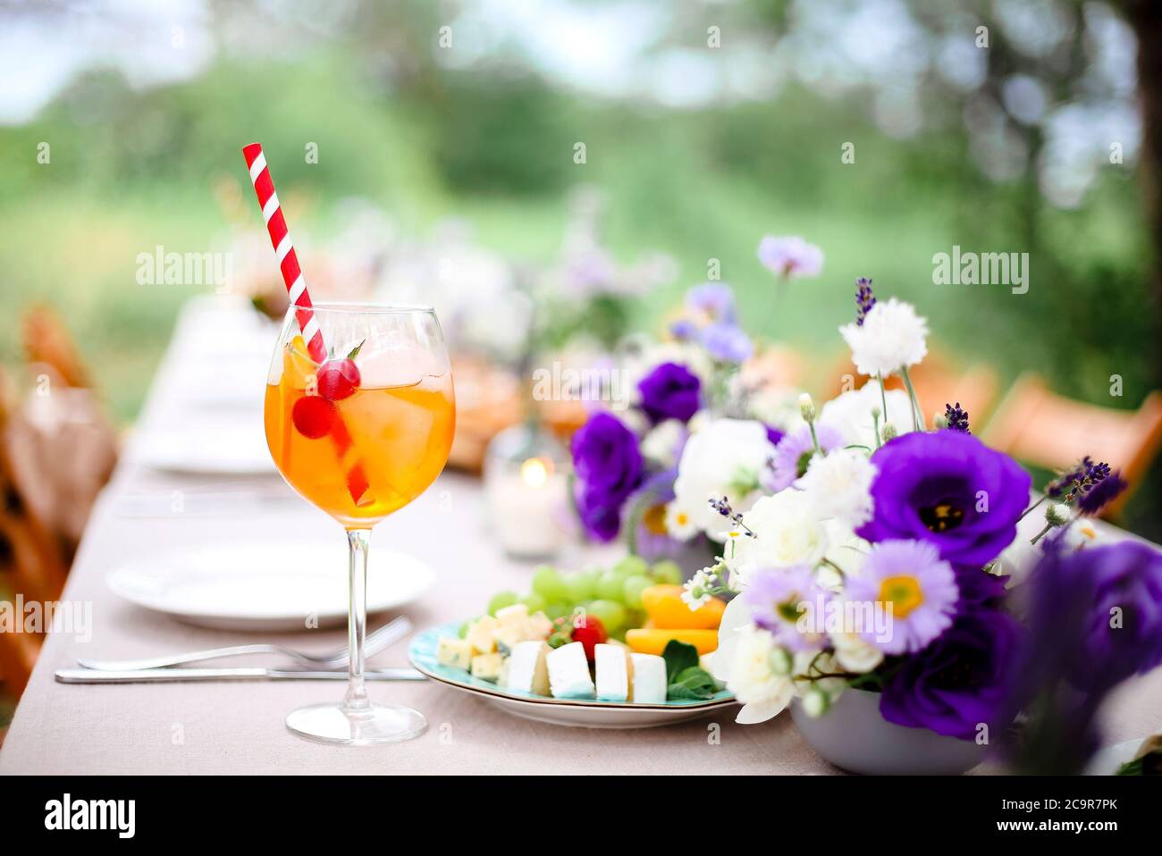 Glass of delicious Aperol spritz drink with straw placed on banquet ...