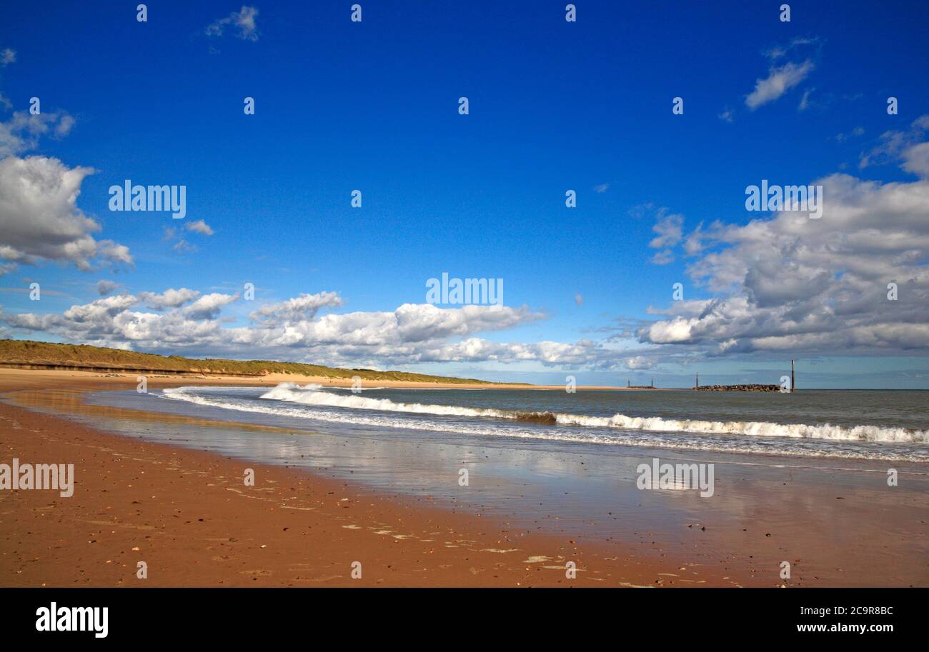 A view of the beach in summer in the North Norfolk seaside village of ...