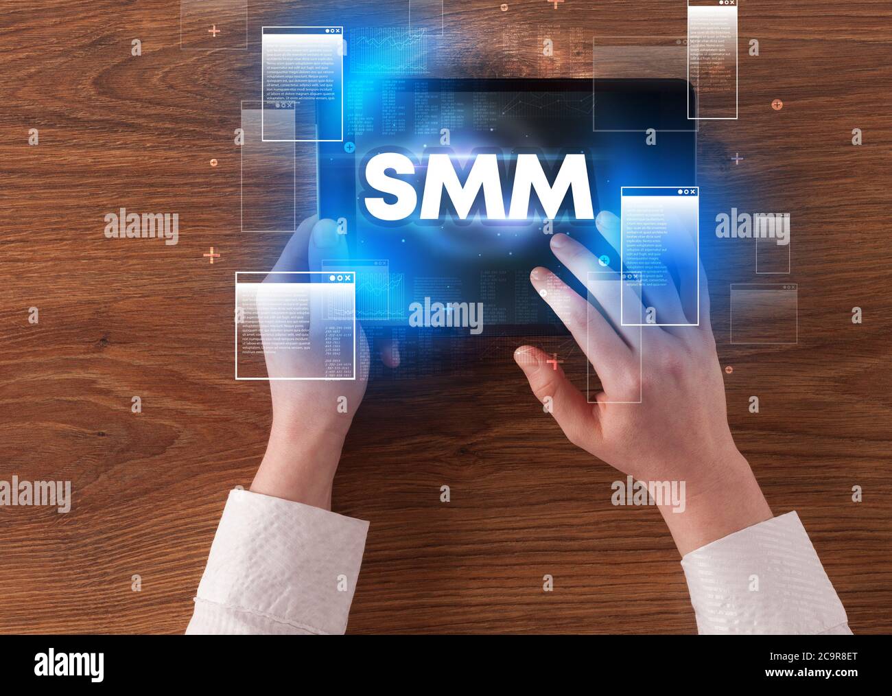 Close-up of a hand holding tablet with SMM abbreviation, modern ...
