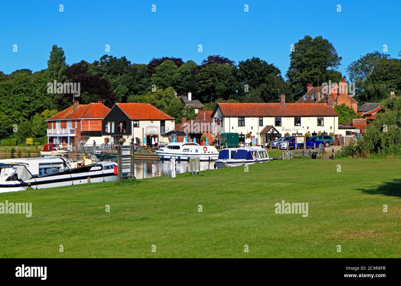 A view of boats moored on the River Bure on the Norfolk Broads by the ...
