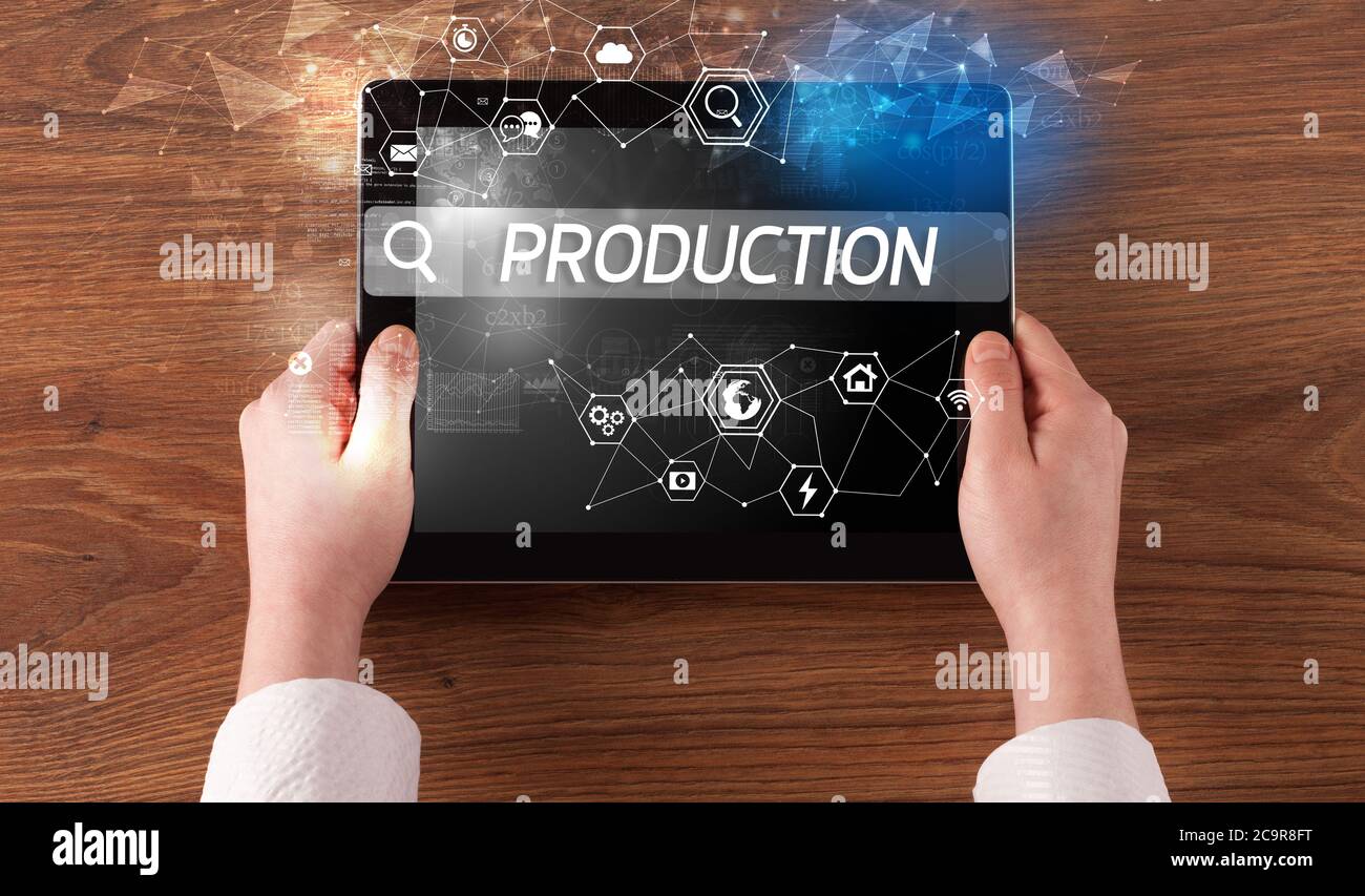 Close-up of a tablet searching PRODUCTION inscription, hi-tech ...