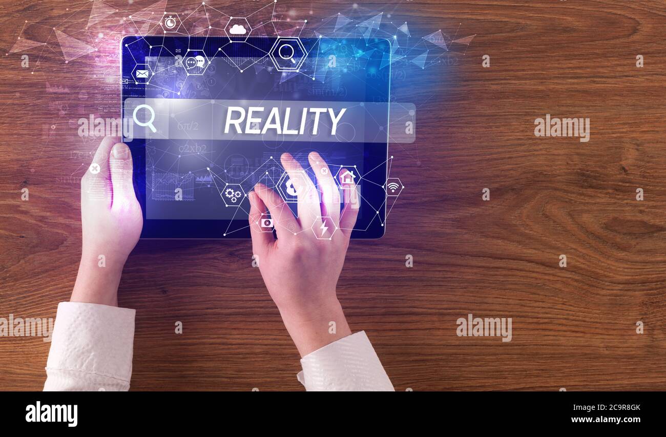 Close-up of a tablet searching REALITY inscription, hi-tech computing ...