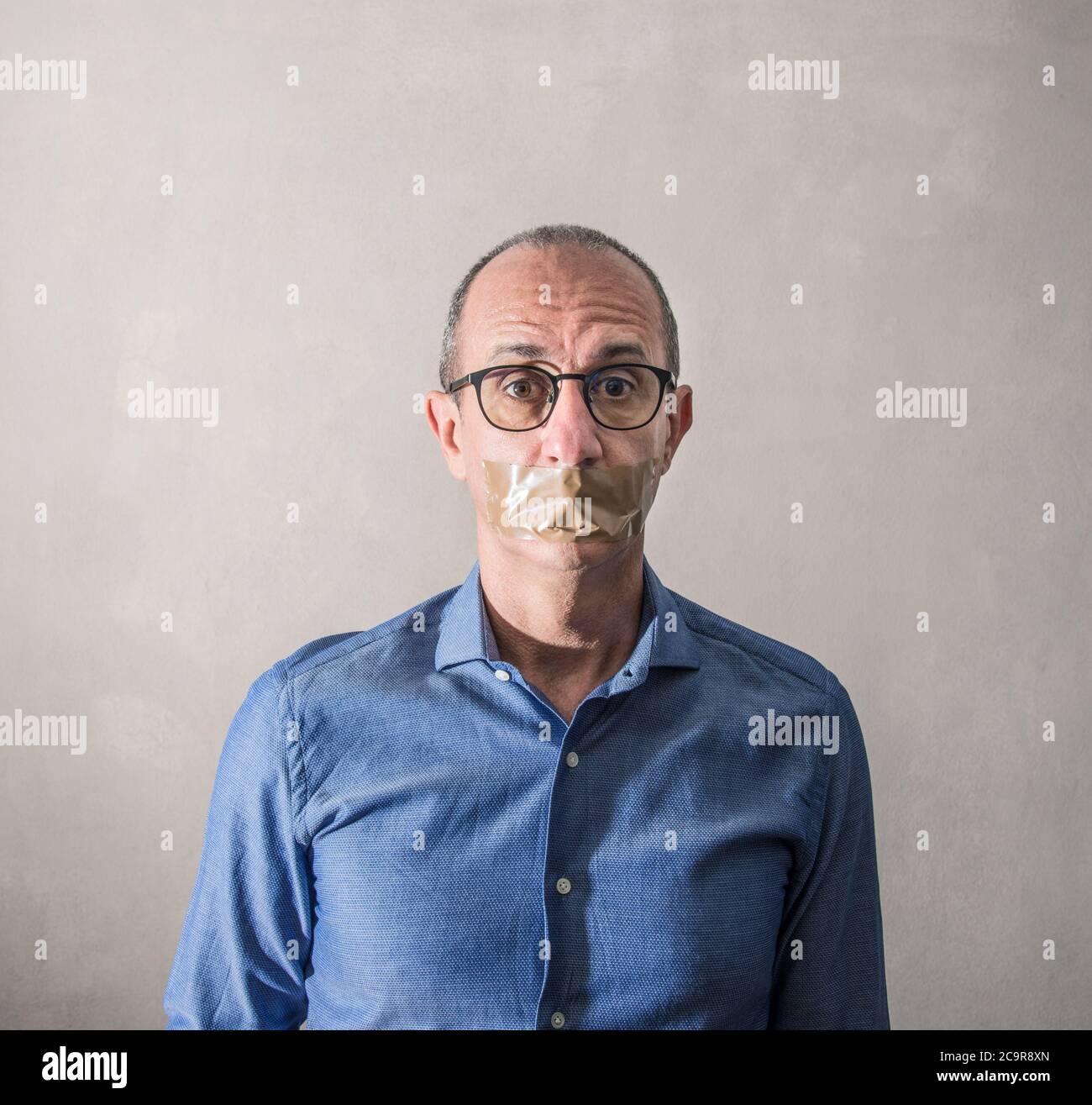 a Man with duct tape on mouth Stock Photo - Alamy