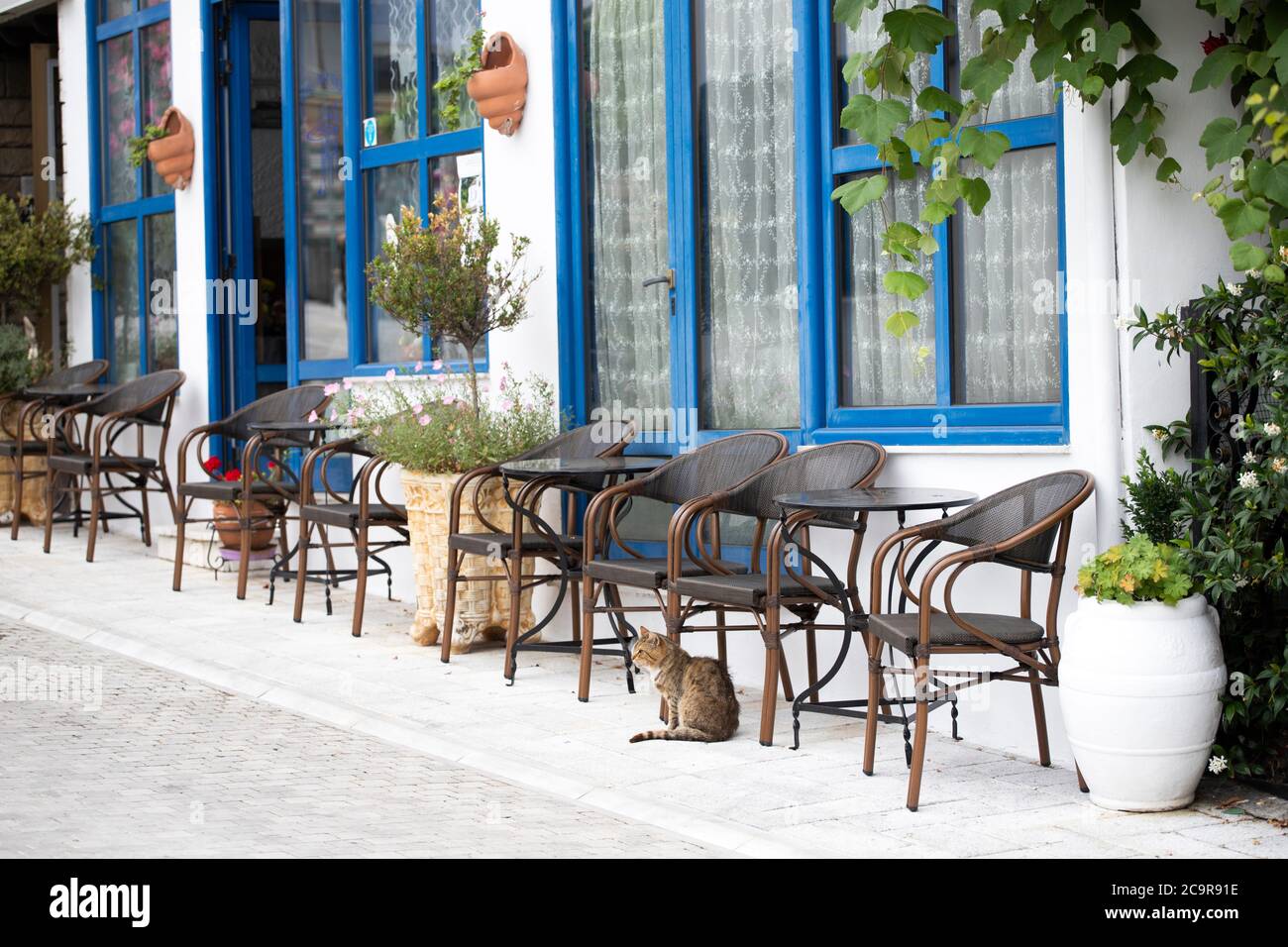Mediterranean restaurant terrace exterior with chairs. Holiday travel ...