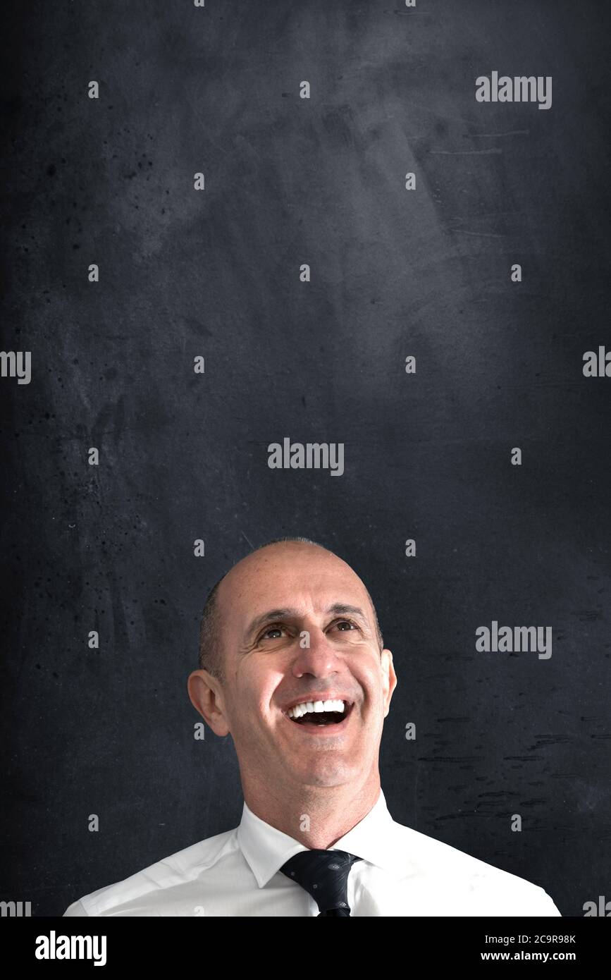 business man looking up smiling Stock Photo - Alamy