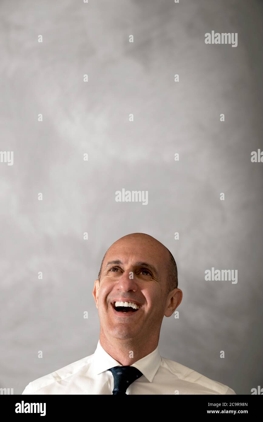 business man looking up smiling Stock Photo - Alamy