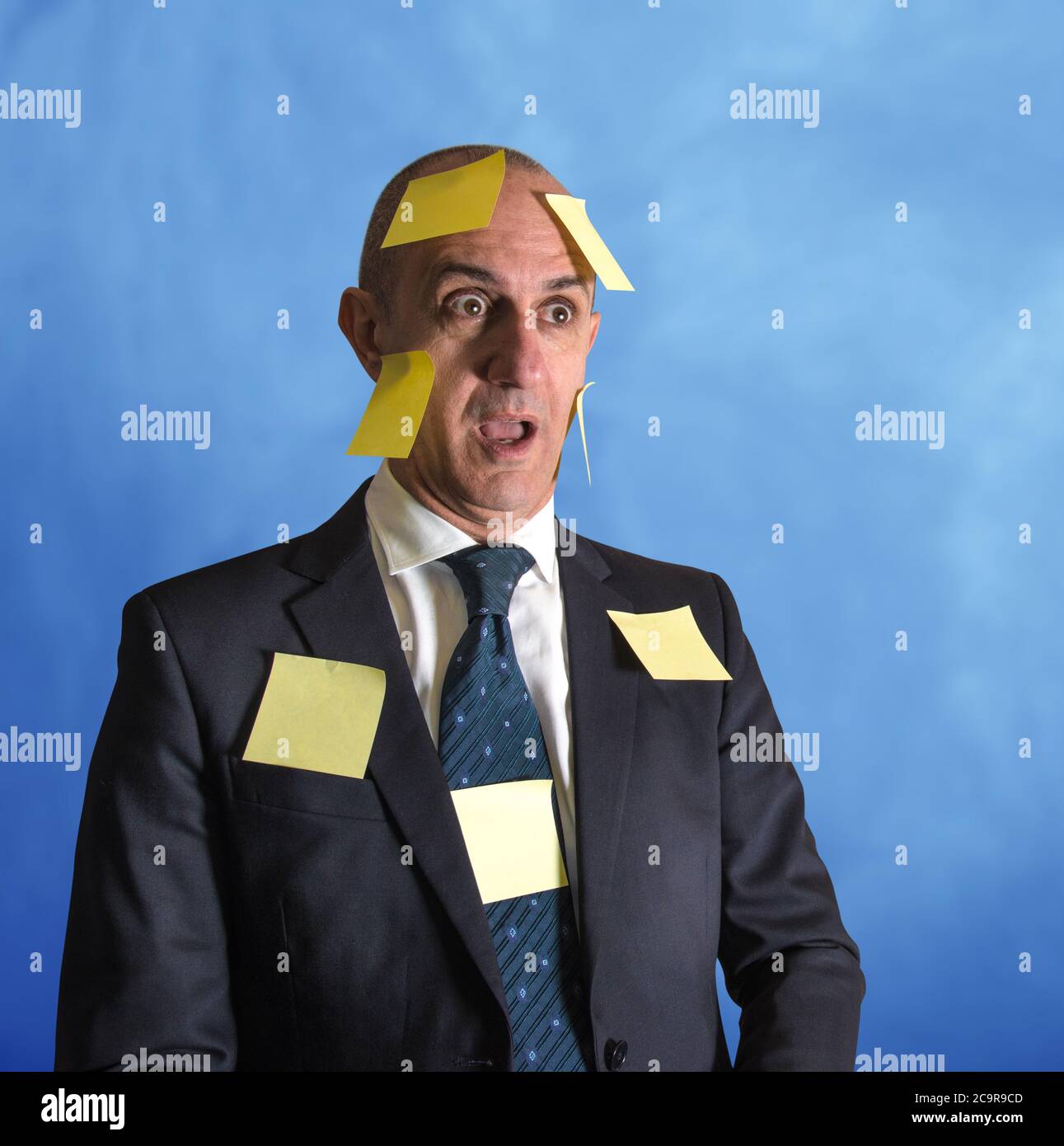Stressed businessman with post-it head Stock Photo - Alamy