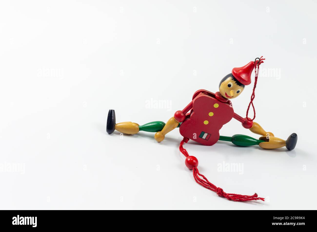 The wooden doll toy has a red-green color on a white background Stock ...