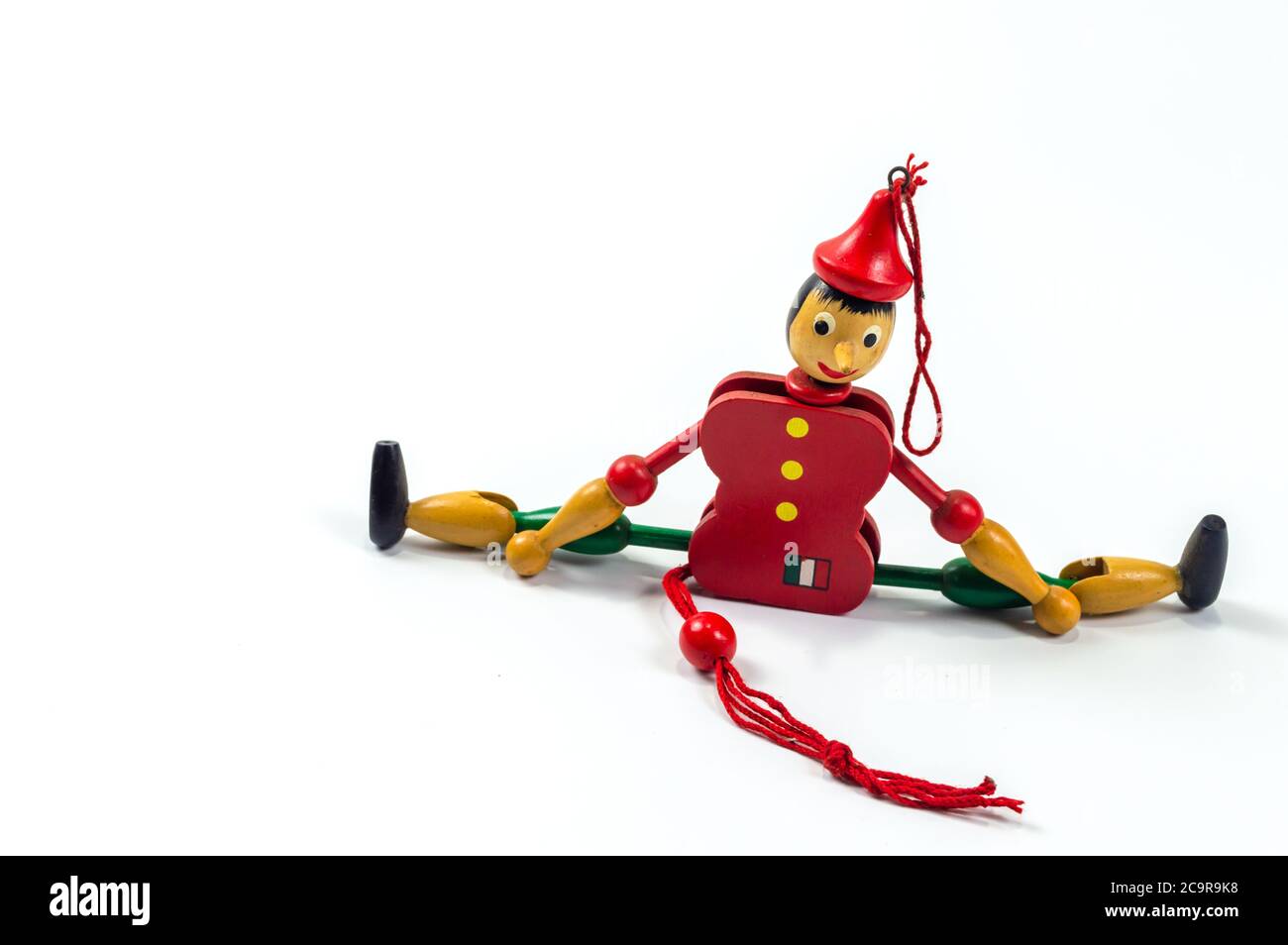The wooden doll toy has a red-green color on a white background Stock ...