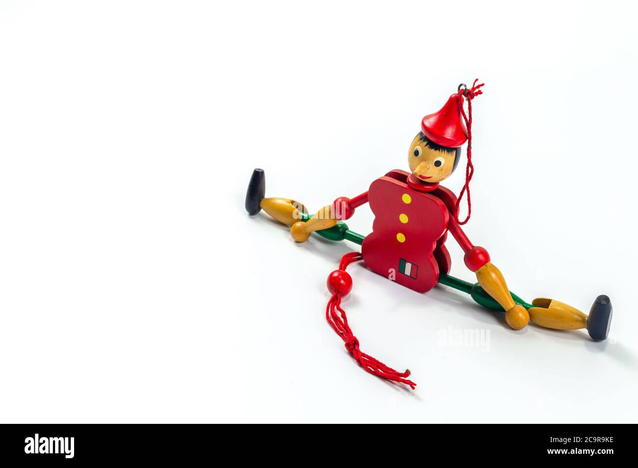The wooden doll toy has a red-green color on a white background Stock ...