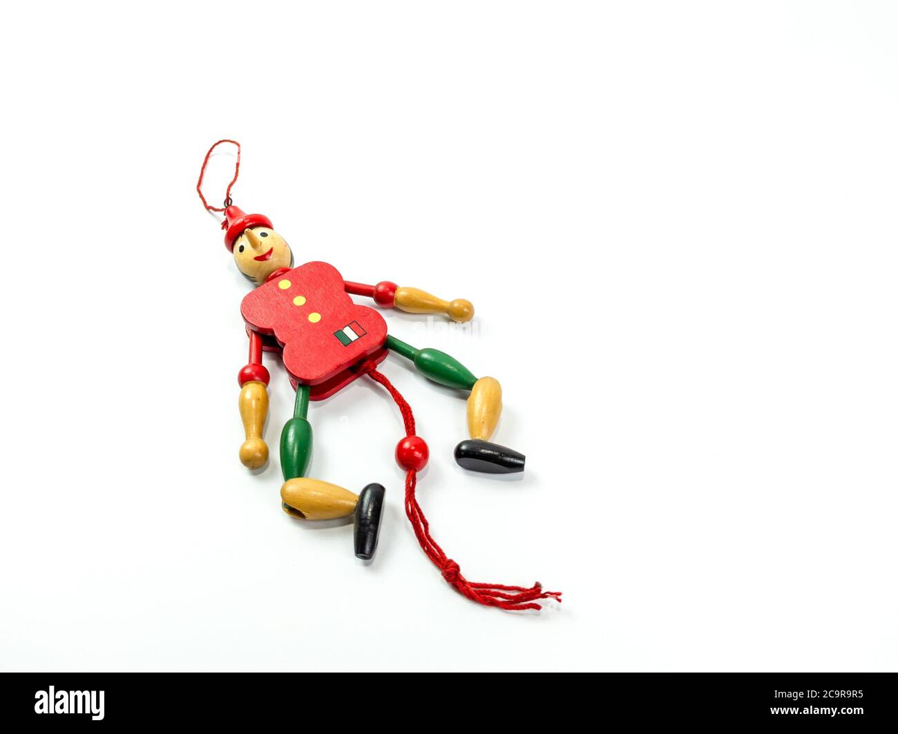 The wooden doll toy has a red-green color on a white background Stock ...