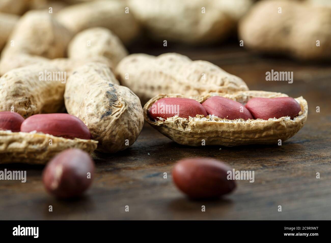 Inshell peanuts sprinkled on a wooden background. place for text Stock ...