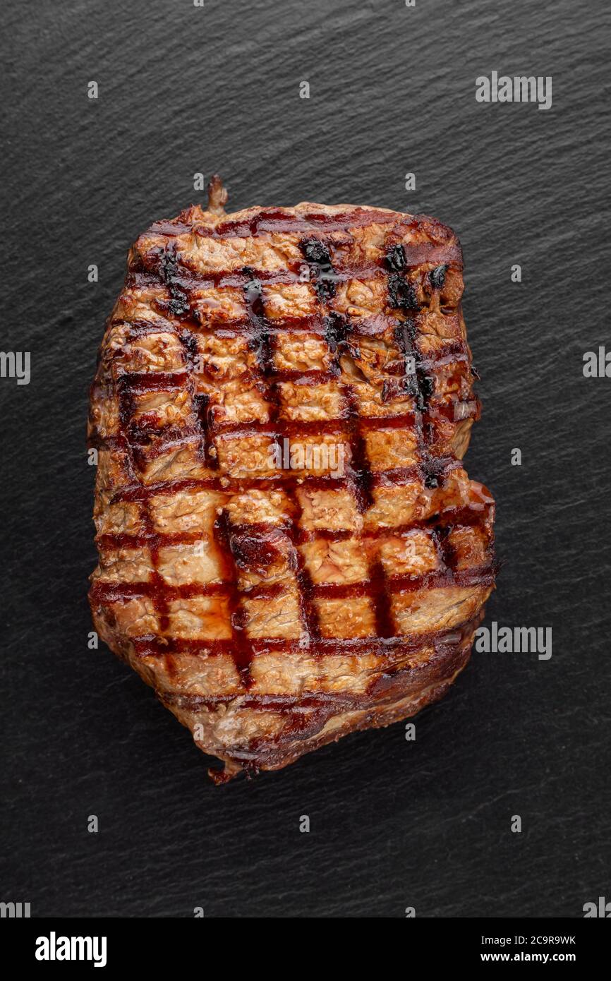 Grilled beef steak on a slate board Stock Photo - Alamy