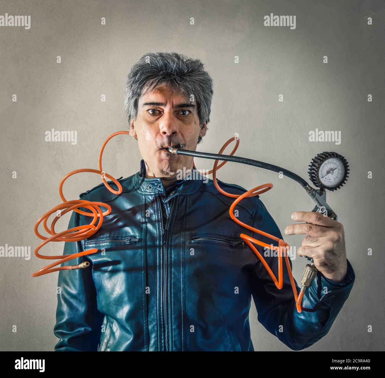 a Stressed man with manometer in mouth Stock Photo - Alamy