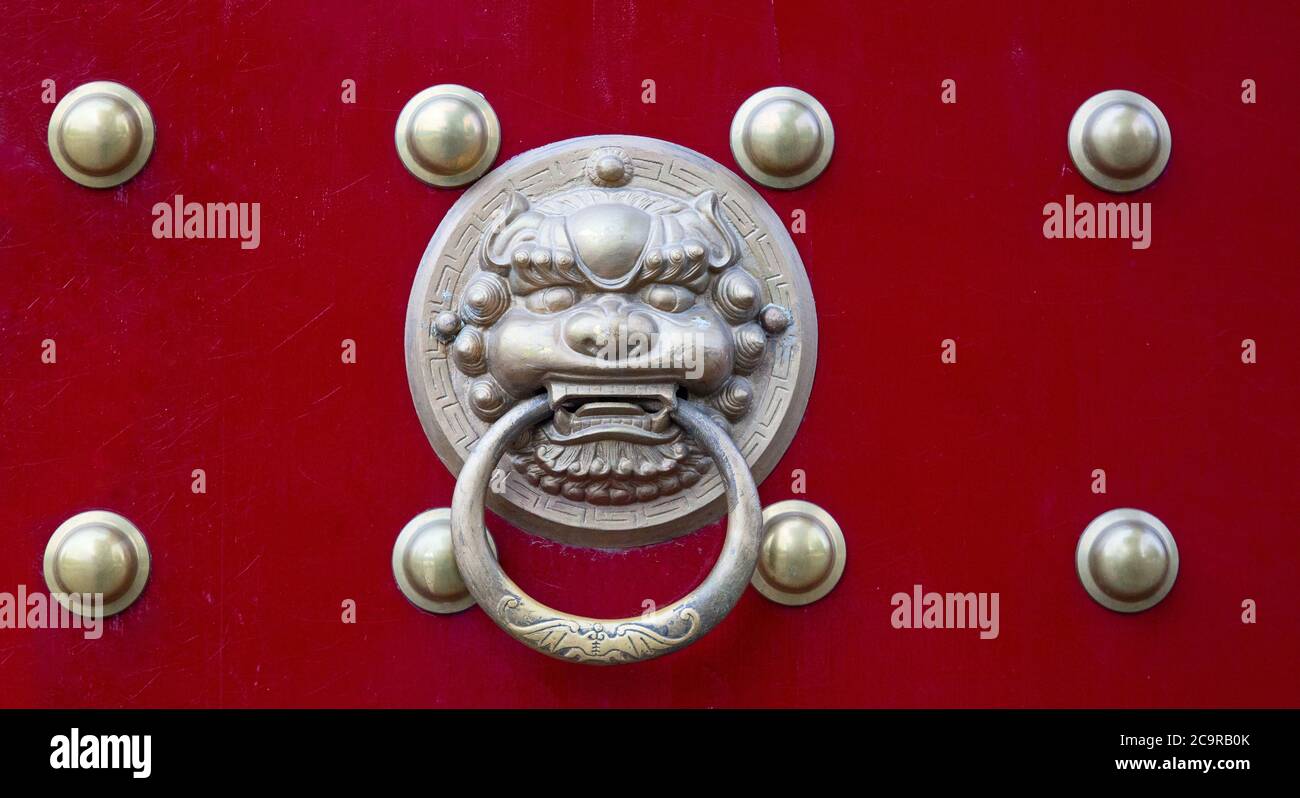 Traditional chinese entrance gate, red wood and brass lion Stock Photo ...