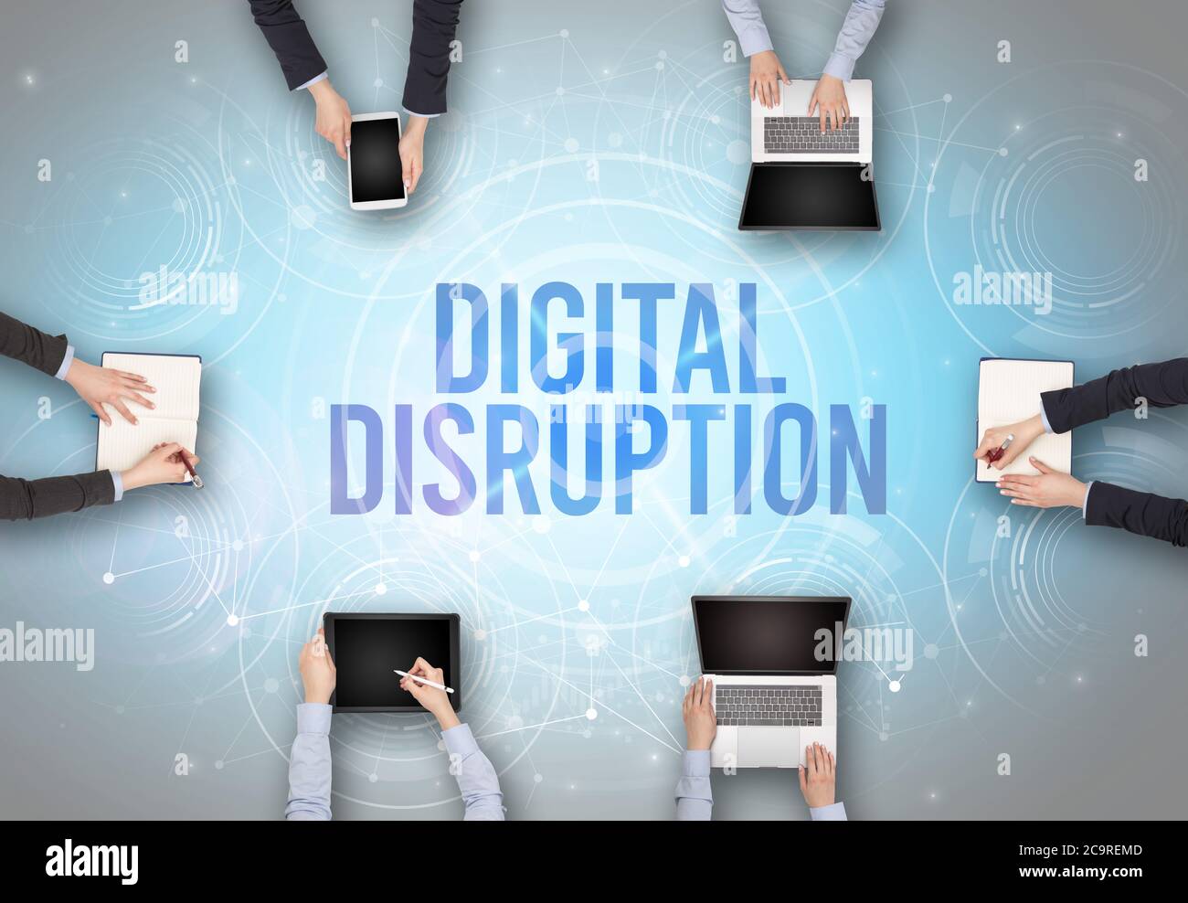 Group of people in front of a laptop with DIGITAL DISRUPTION insciption ...