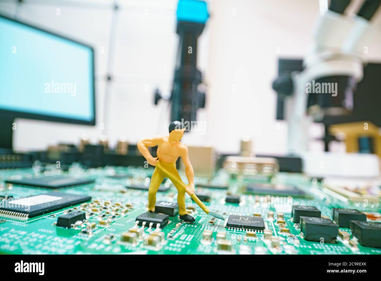 Miniature repair man on mainboard, Miniature figure of worker team try ...