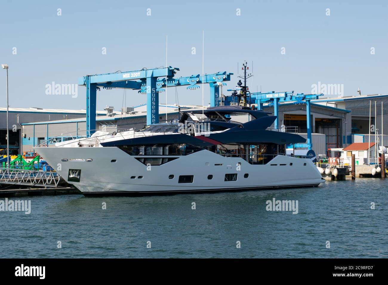 Sunseeker shipyard, Poole, Dorset, UK with yacht in water and crane in ...
