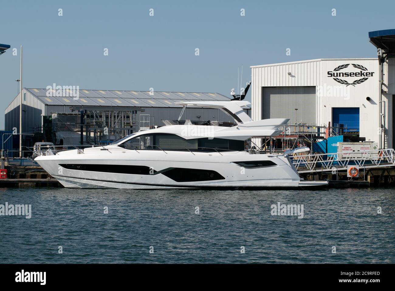 Sunseeker shipyard in Poole, Dorset UK with yacht in water and logo on ...
