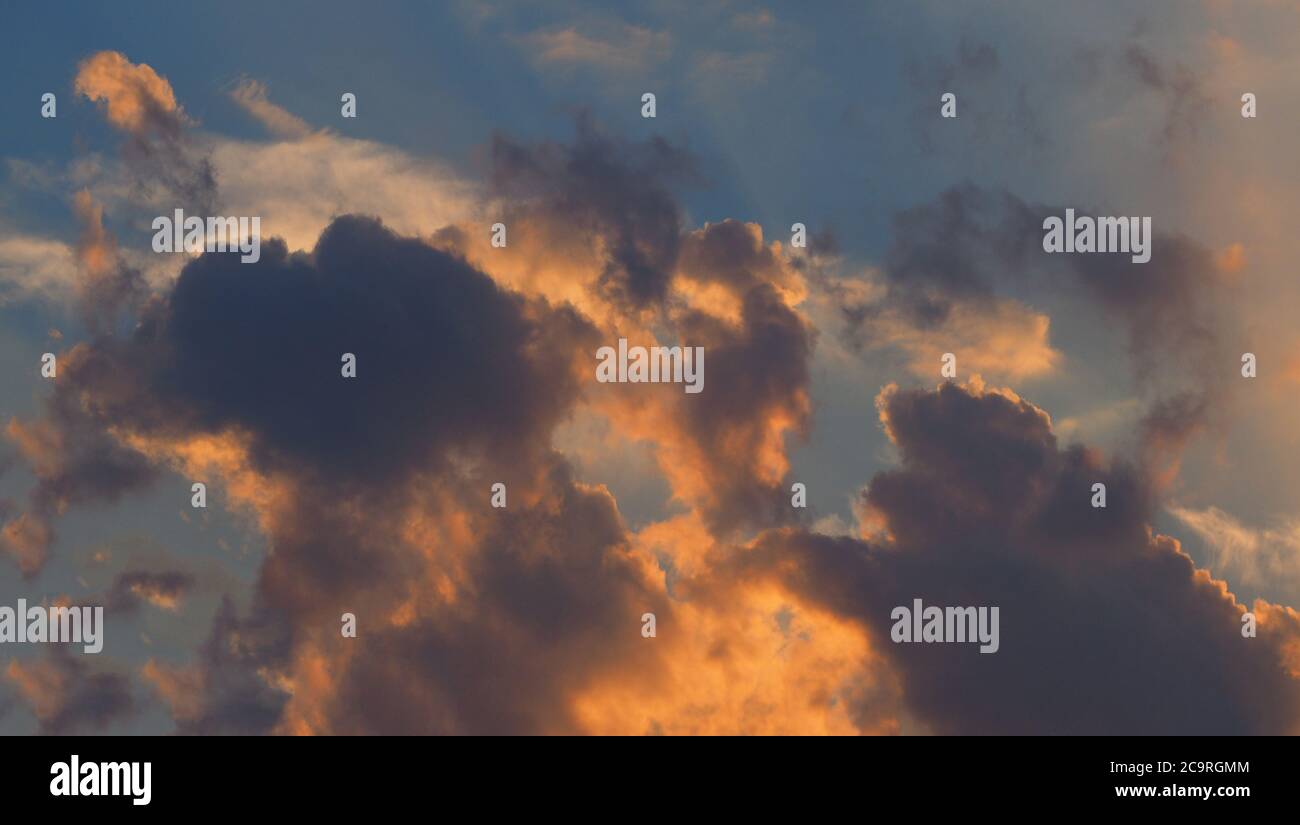 dramatic orange blue clouds sky background Stock Photo - Alamy