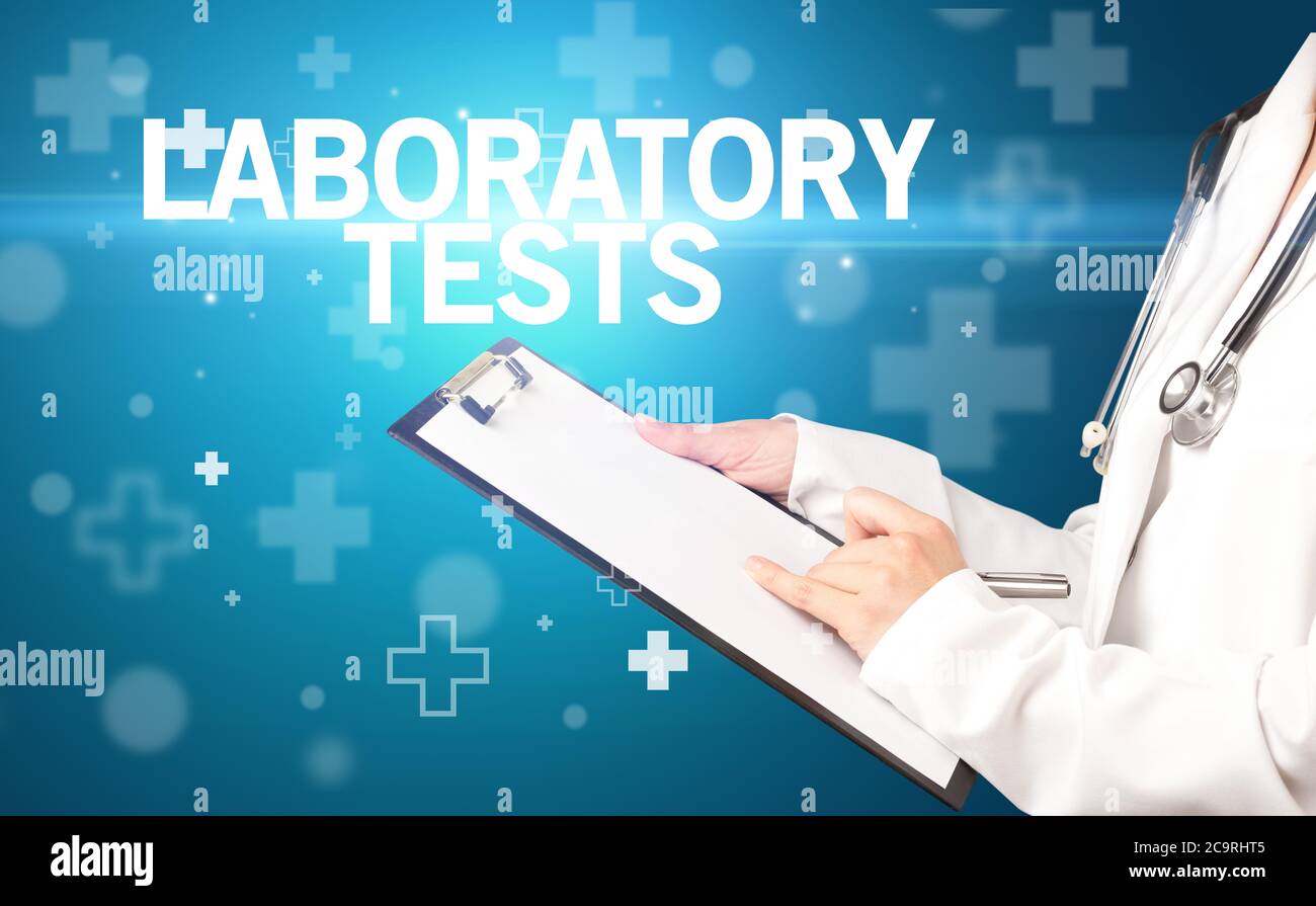 doctor writes notes on the clipboard with LABORATORY TESTS inscription ...