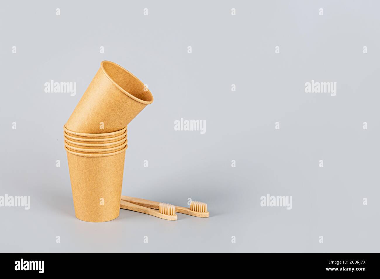 eco natural paper cups, bamboo toothbrush on gray background ...