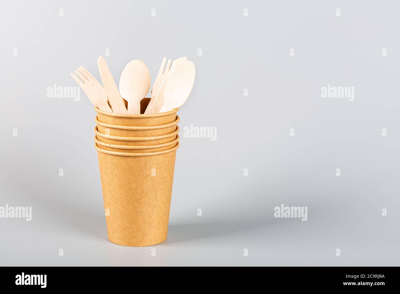 eco natural paper cups and wooden cutlery on gray background ...