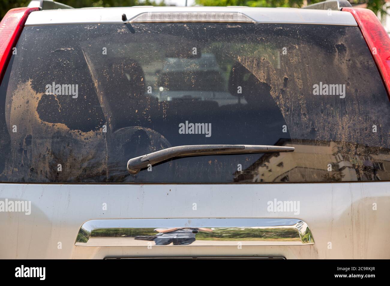 Dirty car in dust view of glass of a rear view and boot lid Stock Photo ...