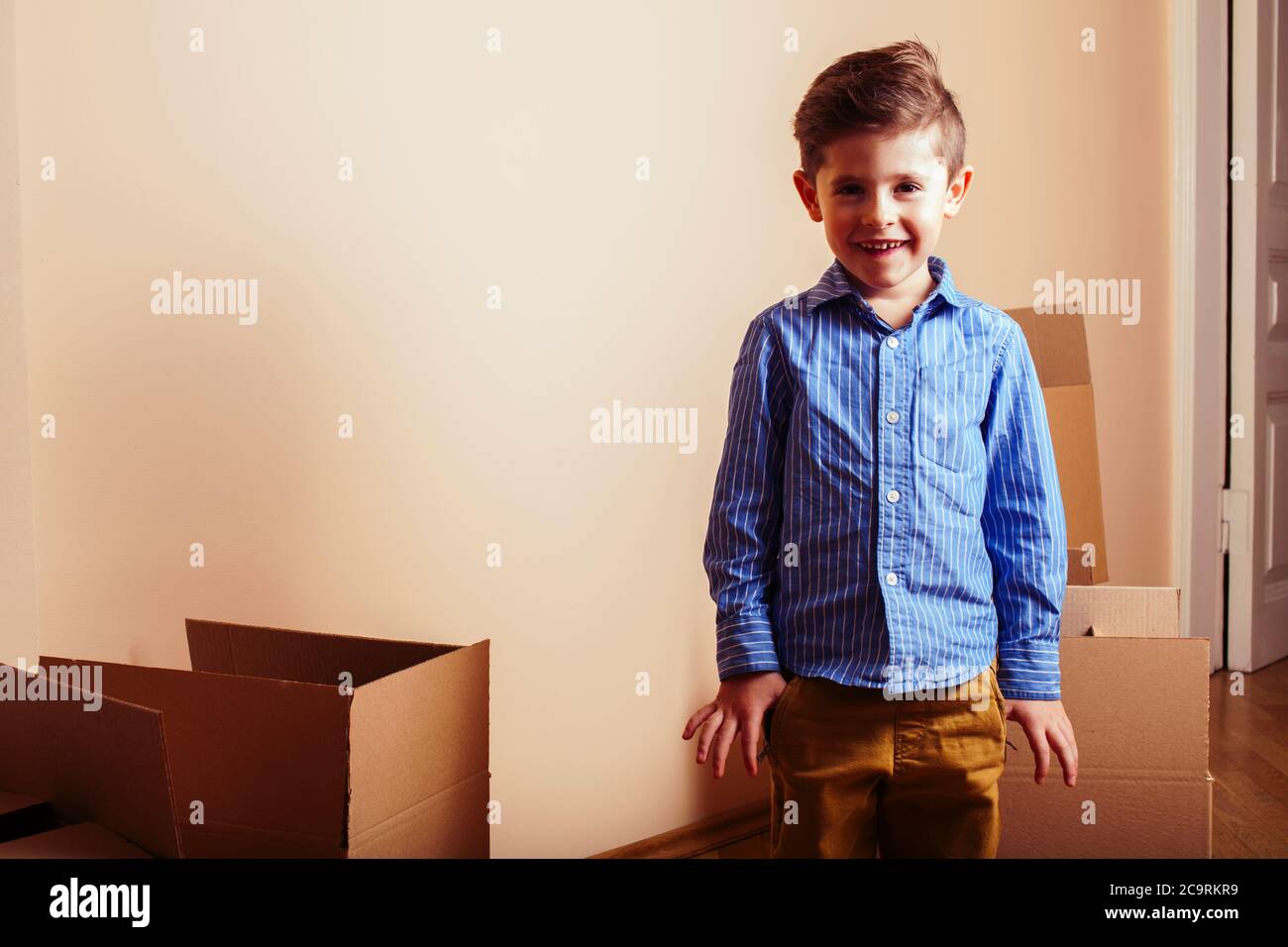 little cute boy in empty room, move to new house. home alone among ...