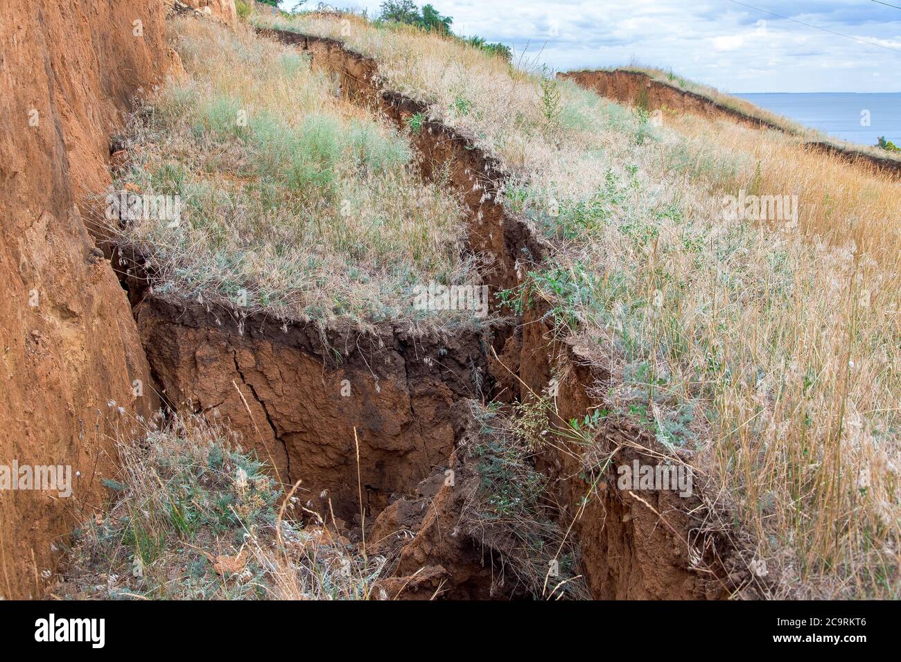 landslide with cracks in the ground, the earth sank down Stock Photo ...