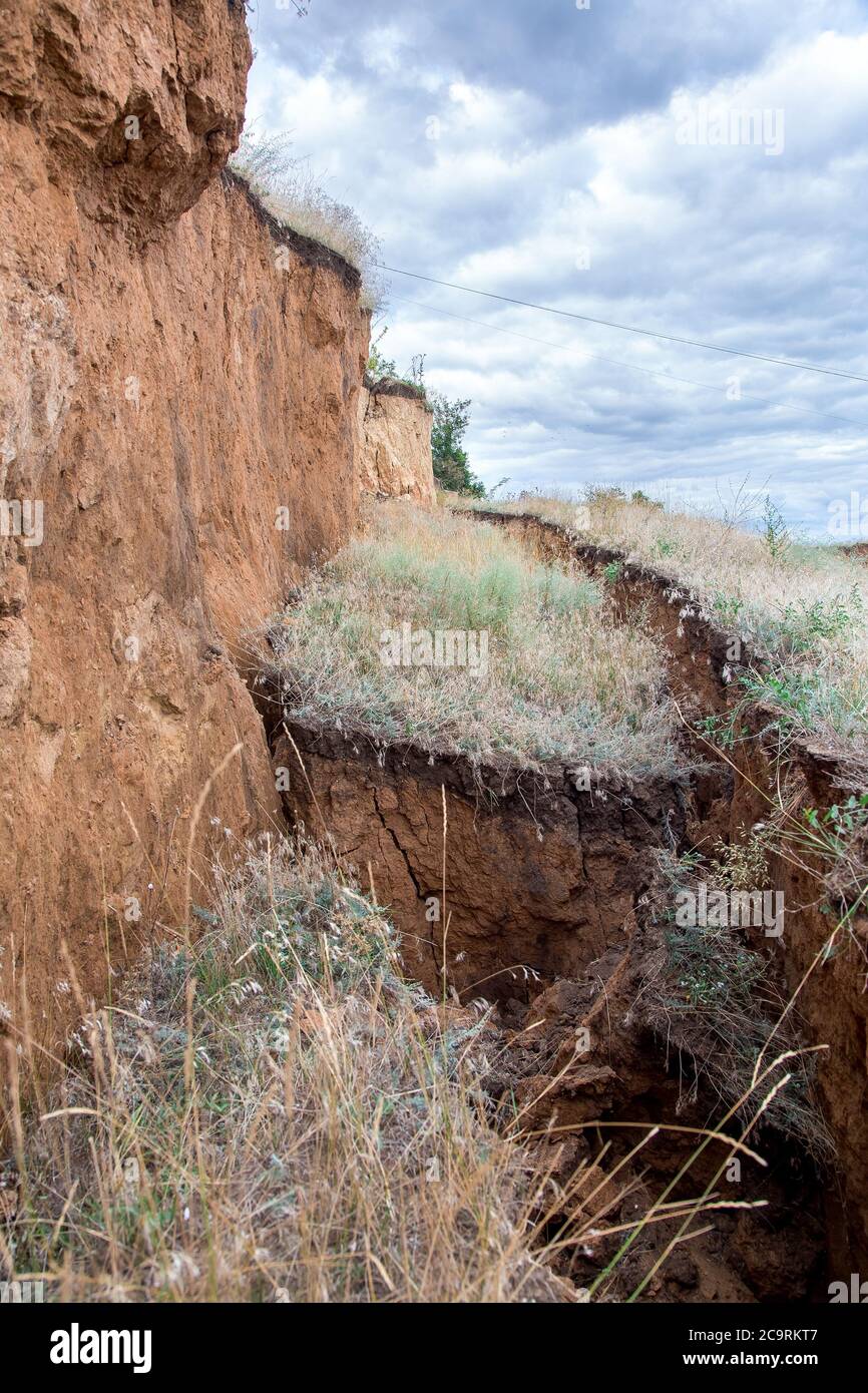 landslide with cracks in the ground, the earth sank down Stock Photo ...
